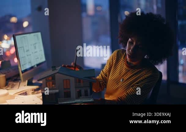 House designer projecting architectural project at office late evening ...