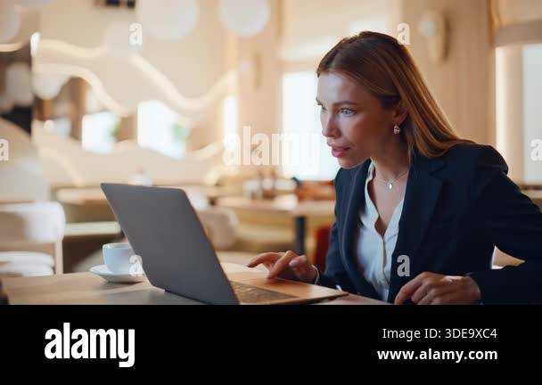 Excited manager receiving email on laptop sitting cozy cafeteria ...