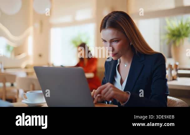 Confident ceo browsing laptop in cafeteria sipping hot espresso closeup ...