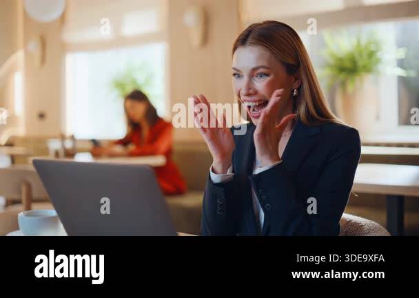 Overjoyed businesswoman looking laptop receiving great news in modern ...