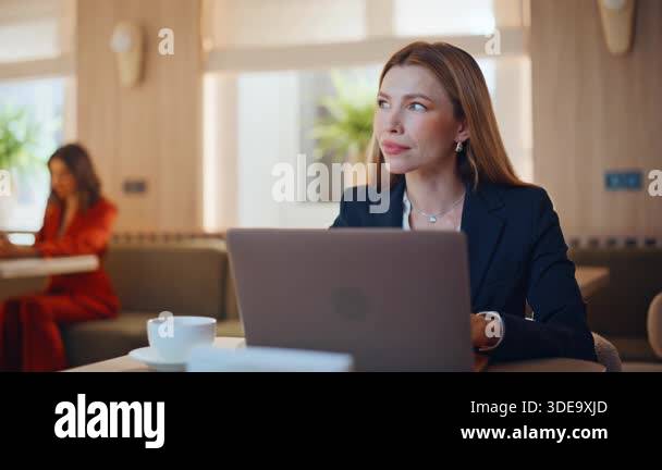 Professional lady browsing laptop in modern cafeteria closeup ...