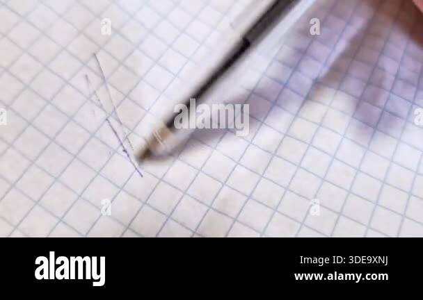 Extreme close-up of a ballpoint pen drawing a series of diagonal lines ...