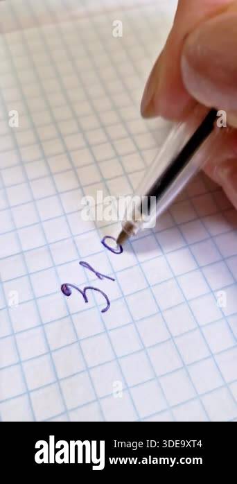 Vertical, Macro view of a hand writing the date 31 december 2026 in ...