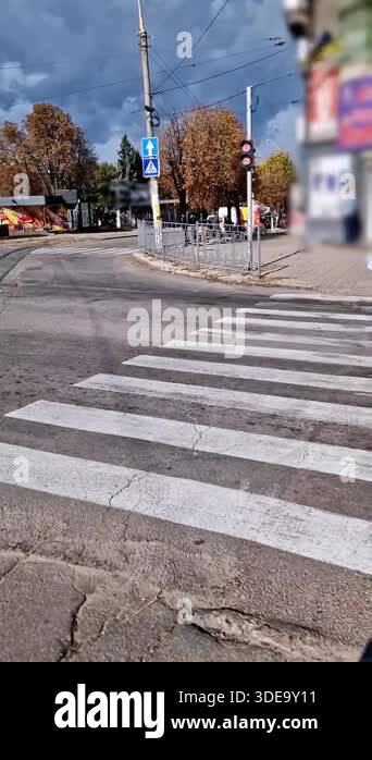 Vertical, Static shot of an empty city street corner. A pedestrian ...