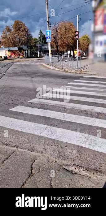 Vertical, an urban street corner with an empty pedestrian crossing. A ...