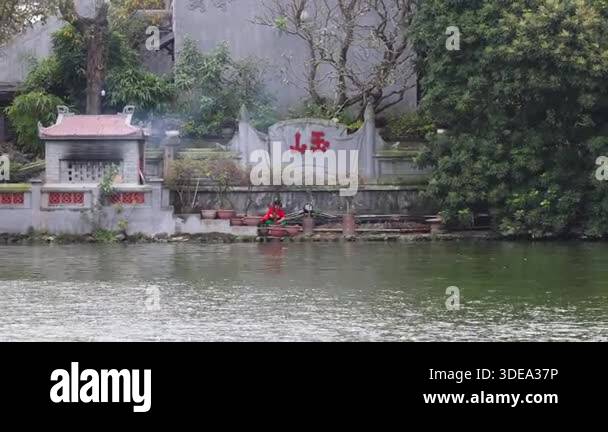 Person rowing a boat on a tranquil lake Stock Video Footage - Alamy