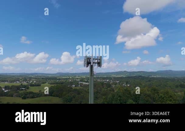 Cell tower rising above lush green landscape Stock Video Footage - Alamy