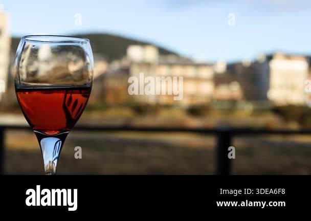 Red wine glass with reflective cityscape background Stock Video Footage ...