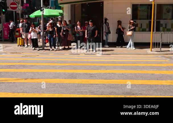 People waiting at a crosswalk in Hong Kong Stock Video Footage - Alamy