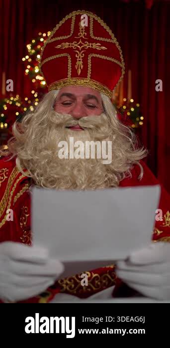 Close-up portrait of St. Nicholas reading a Christmas letter amid ...
