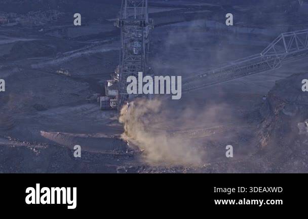 Wide aerial view of a massive excavator operating in an open pit coal ...