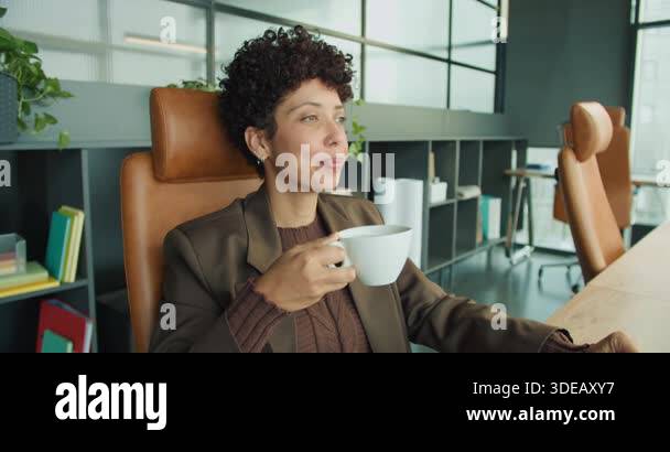 creative director enjoying coffee and smiling at laptop, optimistic ...
