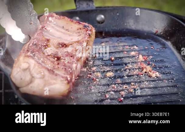 Pork Sizzles Intensely, Grill Marks Appear On Pork, Chef Flips Pork As ...
