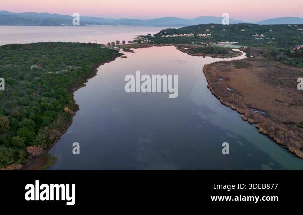 Serene aerial flight over Antinioti Lagoon, Corfu, Greece, showing calm ...