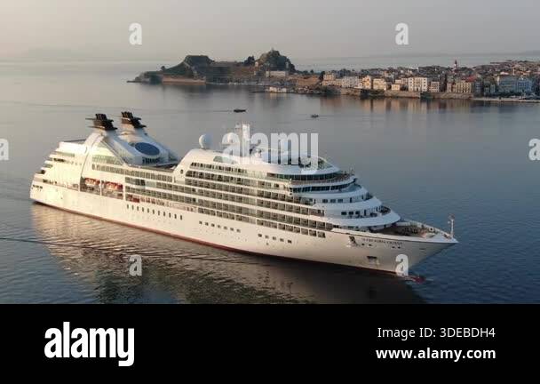 Cinematic aerial tracking shot of large cruise ship entering Corfu ...