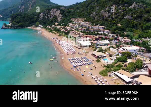 Angled aerial view of sandy Glyfada beach resort in Corfu showing ...