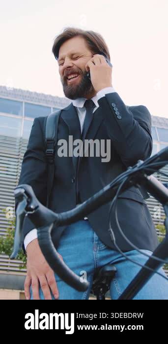 Good-tempered smiling stylish bearded 30-aged man in black jacket and ...