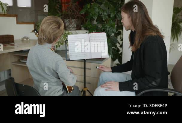 Male Teacher Gives Music Lesson for a Child. Man is Teaching Kid to ...