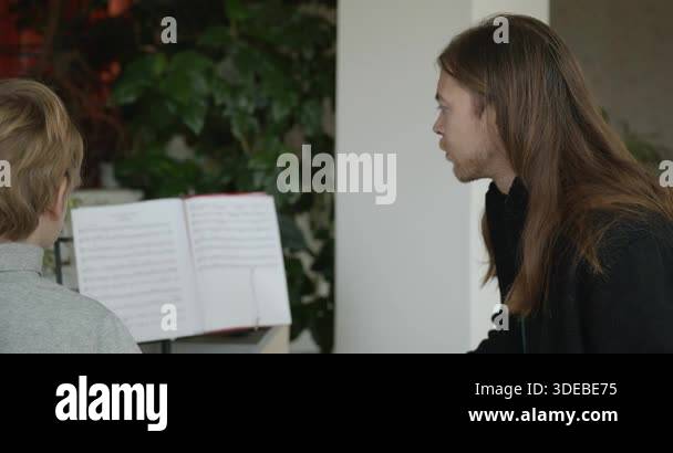 Male Teacher Gives Music Lesson for a Child. Man is Teaching Kid to ...