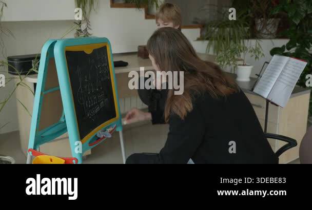 Male Teacher Gives Music Lesson for a Child. Man is Teaching Kid to ...