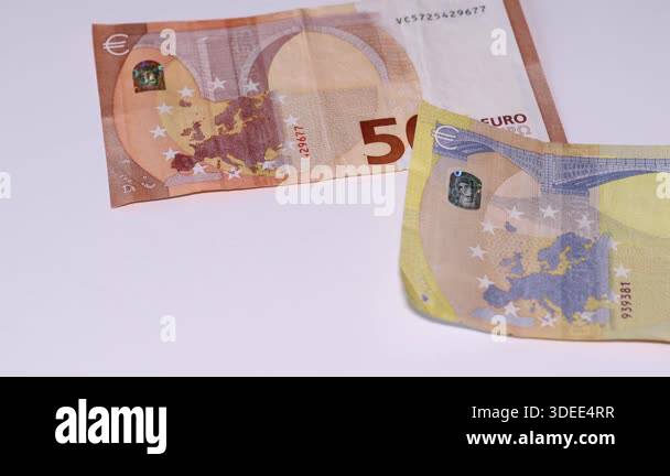 Euro banknotes falling onto a table. Close up of euro cash in motion ...