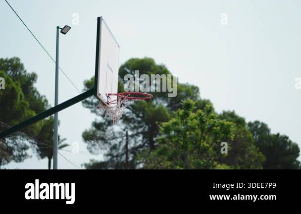 Unsuccessful basketball shot missing the hoop on an outdoor court with ...