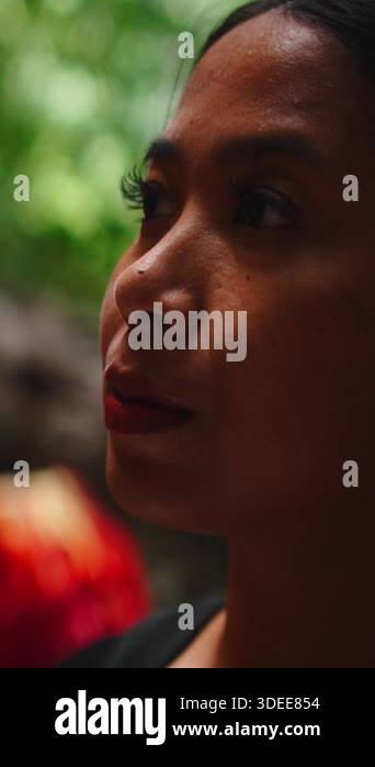 Beautiful young thai woman making a religious offering at a buddhist ...