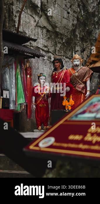 Thai woman making a spiritual offering at a sacred buddhist mountain ...