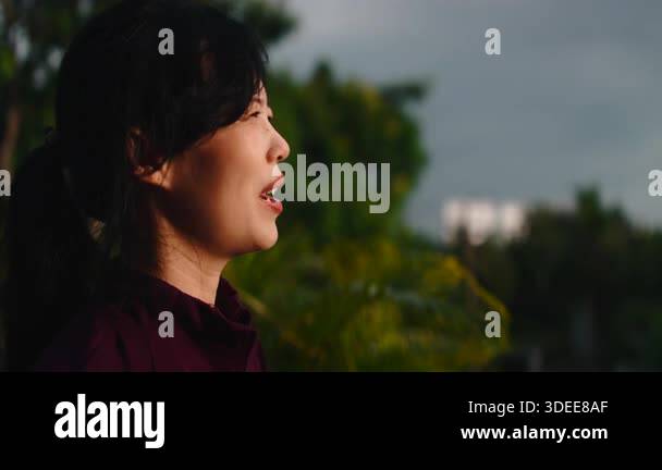 Beautiful asian woman relaxing, meditating, and breathing fresh air in ...