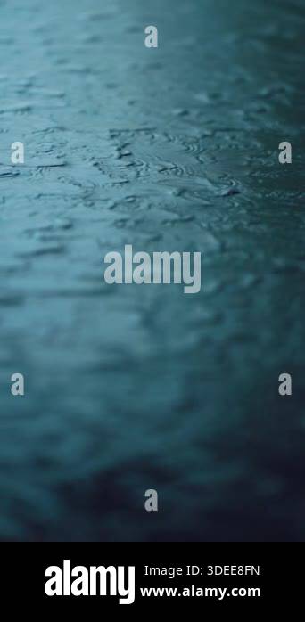 slow motion of water flowing down from modern wall, streams dripping on ...