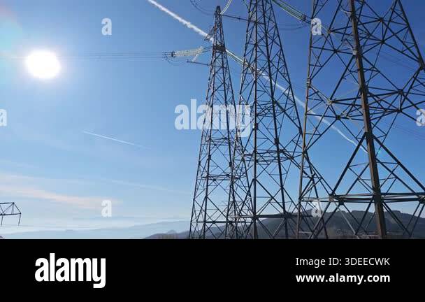 High voltage electricity transmission tower captured from a low angle ...