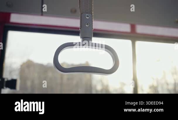 Front view of grey bus handle on empty bus. Bus topping with handle for ...