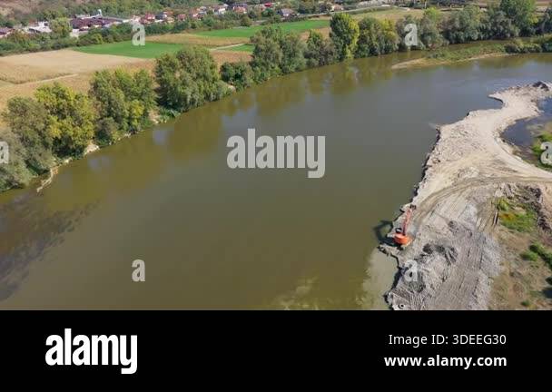 Aerial view of backhoes digging sand and gravel with shovels from the ...