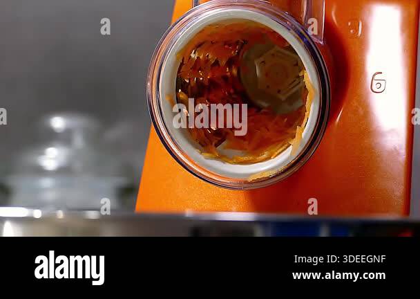 Cutting carrots with an electric cutter Stock Video Footage - Alamy