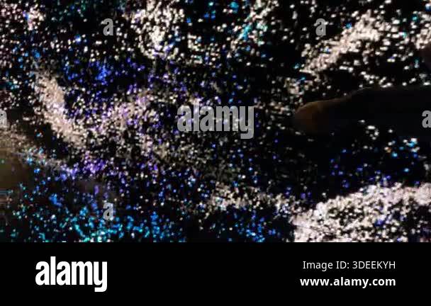 Footage of interactive led screen graphic playing colorful sand and ...