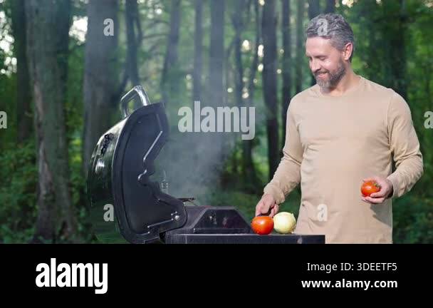 Grill barbeque and chill in nature. Mature man enjoying barbeque ...