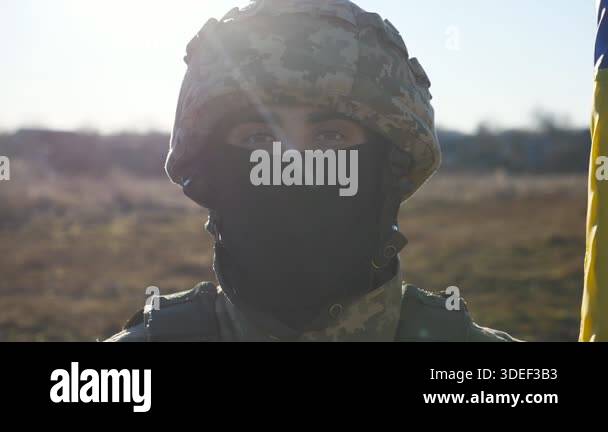 Brown eyes of male ukrainian army soldier in helmet and balaclava ...