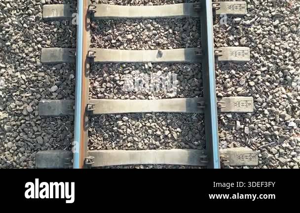 Close-up view of railway tracks showcasing metal rails and gravel, with ...