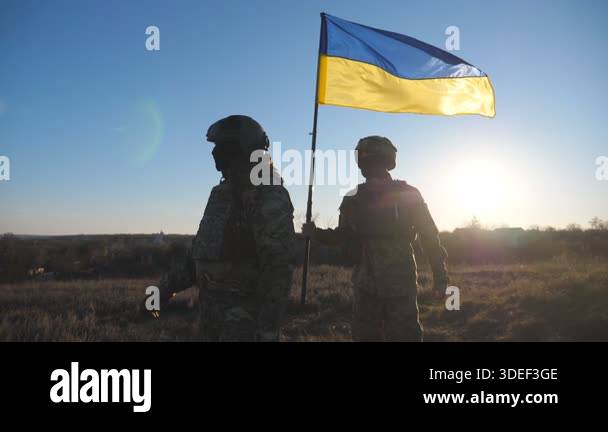 Young woman and man in military uniform going with blue-yellow banner ...