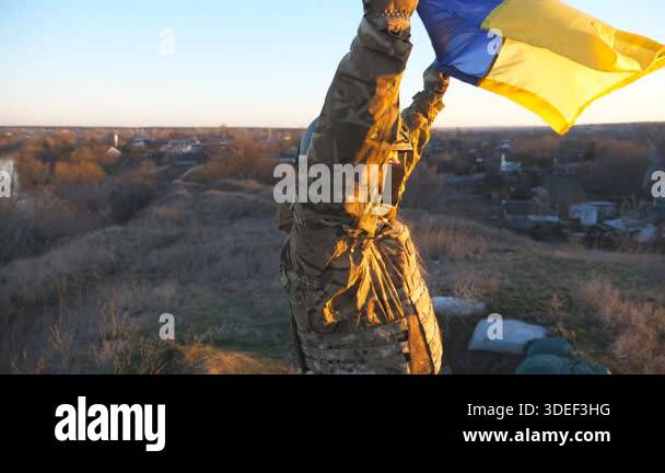 Dolly shot of female soldier of ukrainian army a raised over head blue ...