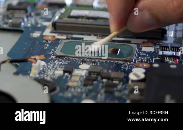 Cleaning the processor crystal with a cotton swab soaked in alcohol ...
