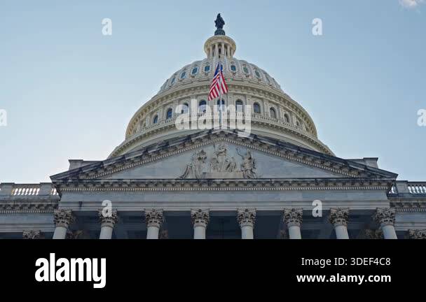 Historic Capitol by the national flag. Capitol dome as symbol of law ...
