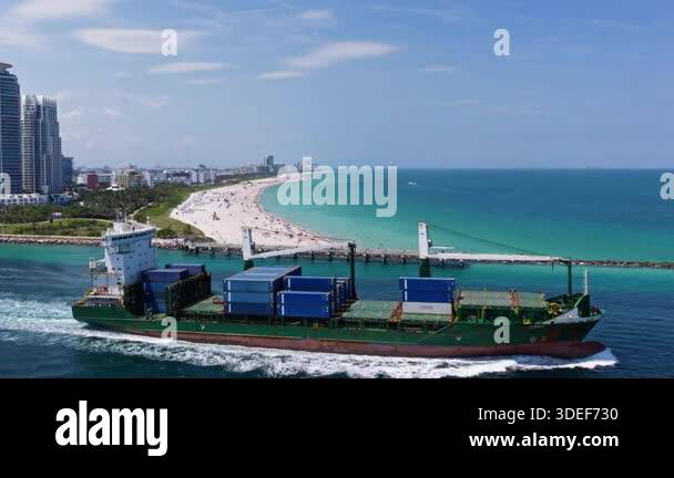 Miami, Florida, USA - May 31, 2025: Aerial view cargo ship leaving port ...