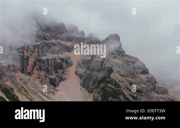 Aerial view of high mountain range covered with clouds. Cristallo ...