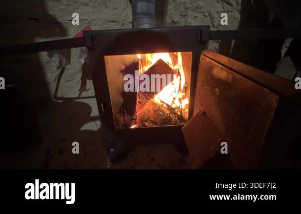 A live fire in a stove with the door open30 seconds of warmth, light ...