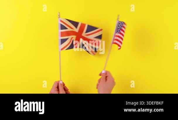 4K stock footage of a hand holding the British flag (Union Jack) in one ...