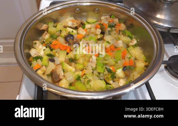 Ragout is cooked in metal pan. Vegetable stew on gas stove. Vegetable ...