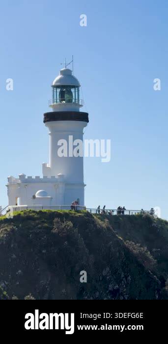 A lighthouse stands prominently on a cliff at Byron Bay, Australia ...