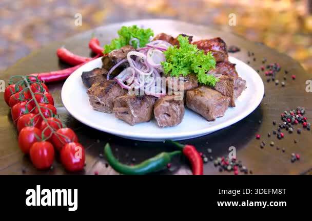 Top view of a delicious grilled sliced beef steak served with green ...