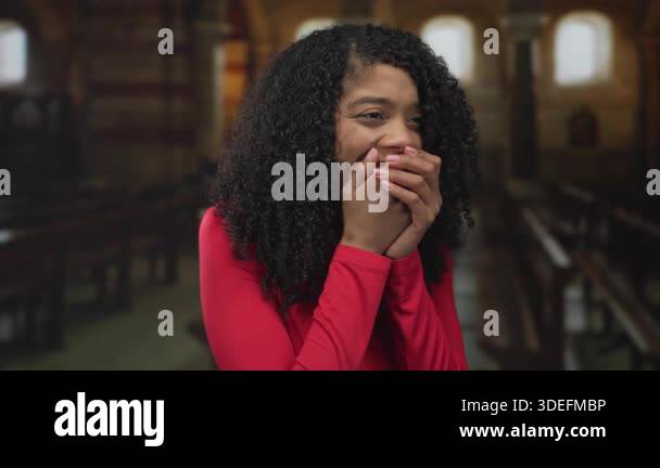 African american woman covering mouth with hands while standing near ...